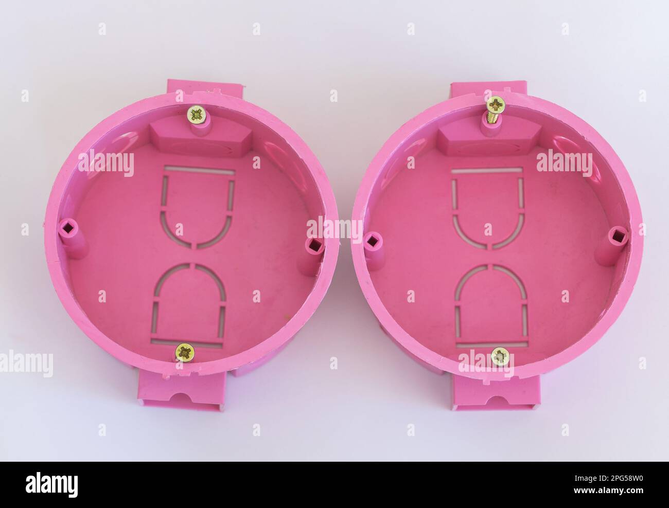 Close-up of two pink plastic socket on a white background Stock Photo ...