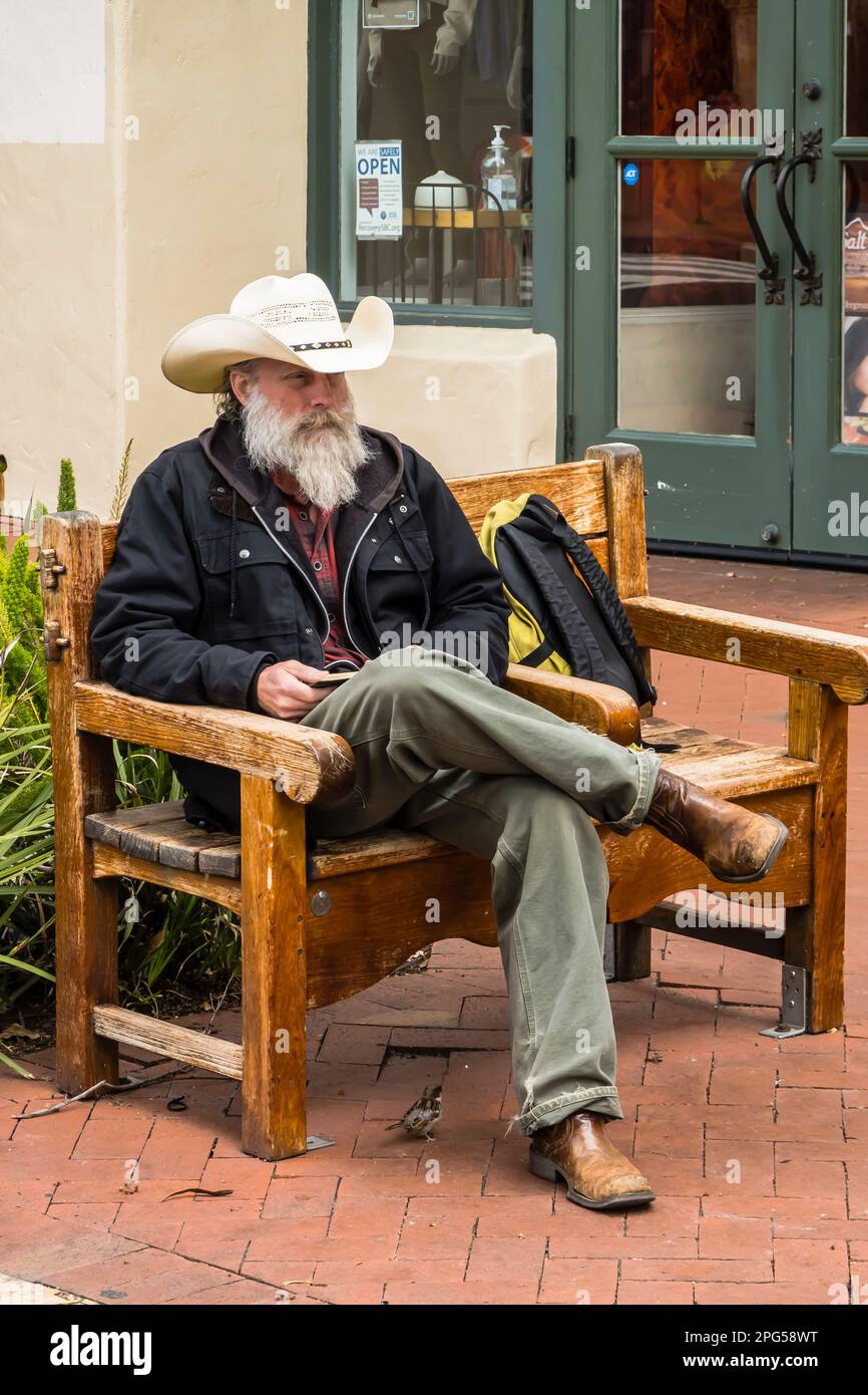 Urban cowboy sitting on a bench in Santa Barbara, California Stock ...