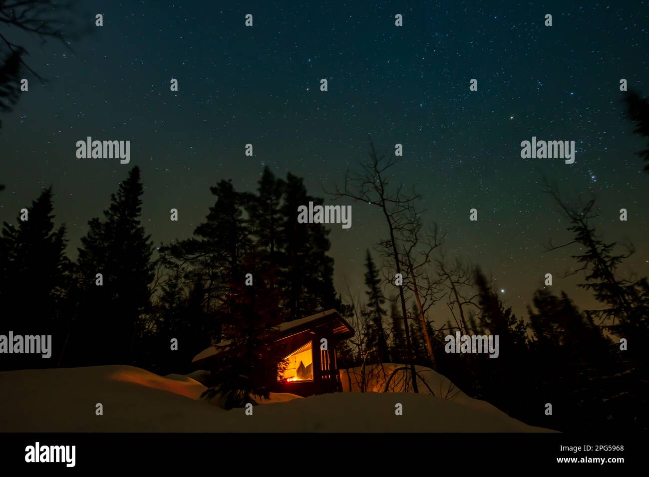 Stars above a remote cabin in the snow in a forest in Norway Stock ...