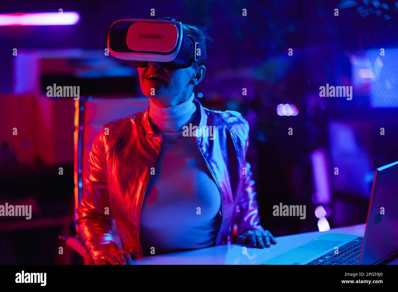 Neon metaverse futuristic concept. surprised modern woman in vr headset ...
