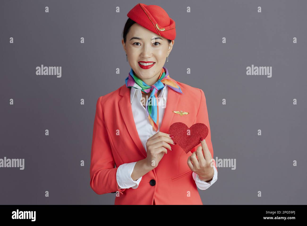 smiling elegant flight attendant asian woman in red skirt, jacket and ...