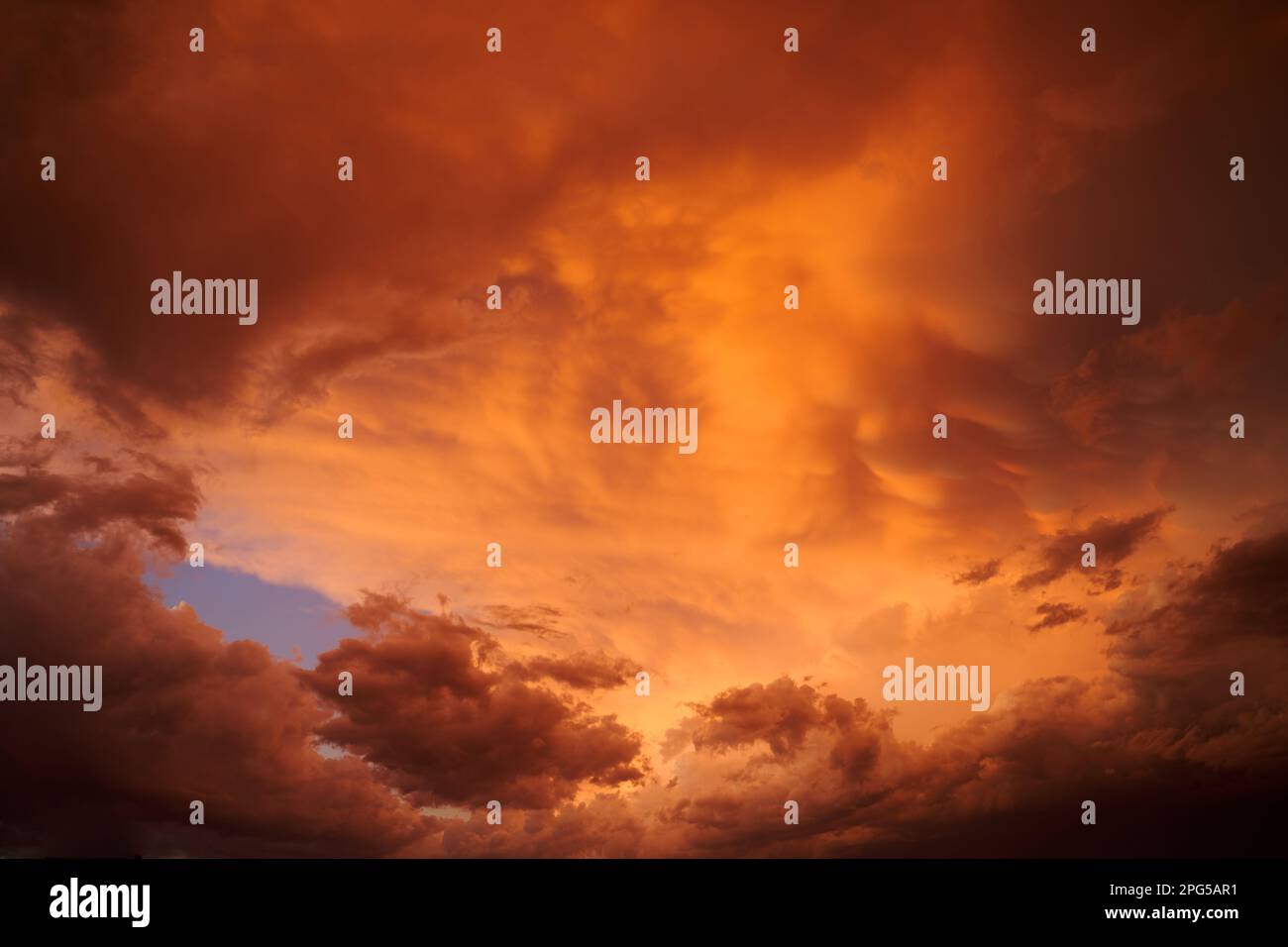 Dramatic late afternoon clouds, illuminated by the setting sun during a ...