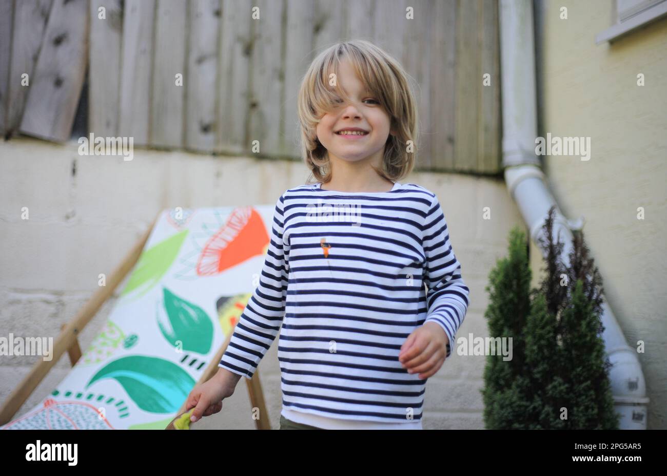 Young boy outside painting Stock Photo - Alamy