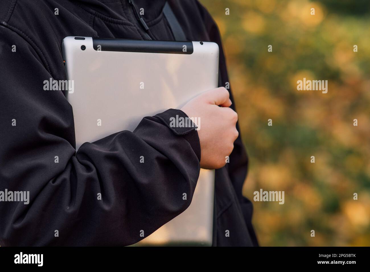 horizontal photo close-up boy with tablet near school with online ...