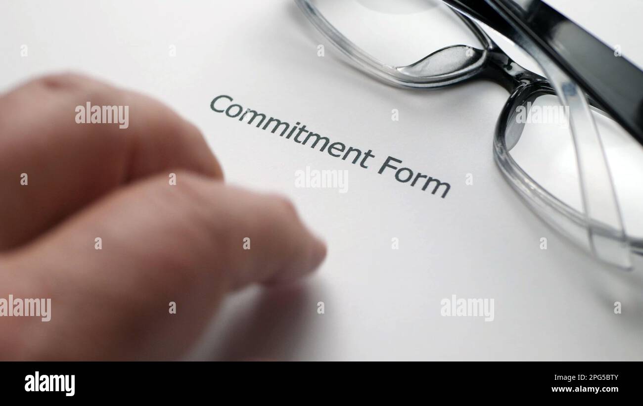 Finger tapping on commitment form Stock Photo - Alamy