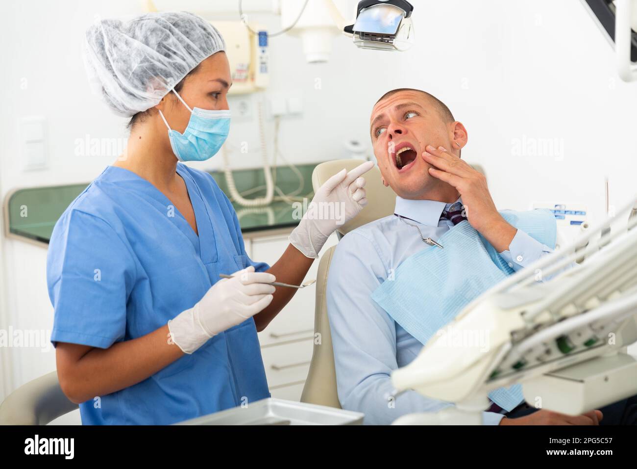 Man complains to the doctor about toothache at dentist appointment ...