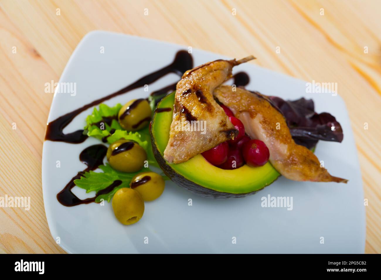 Roasted quail leg quarters with balsamic and vegetables Stock Photo - Alamy