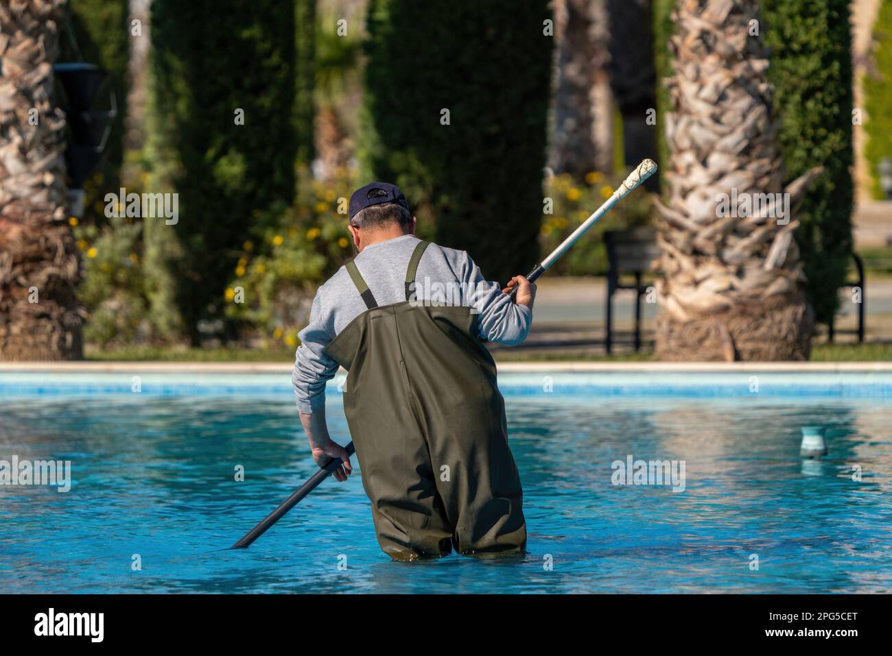 Maintenance worker cleaning the pool Stock Photo - Alamy