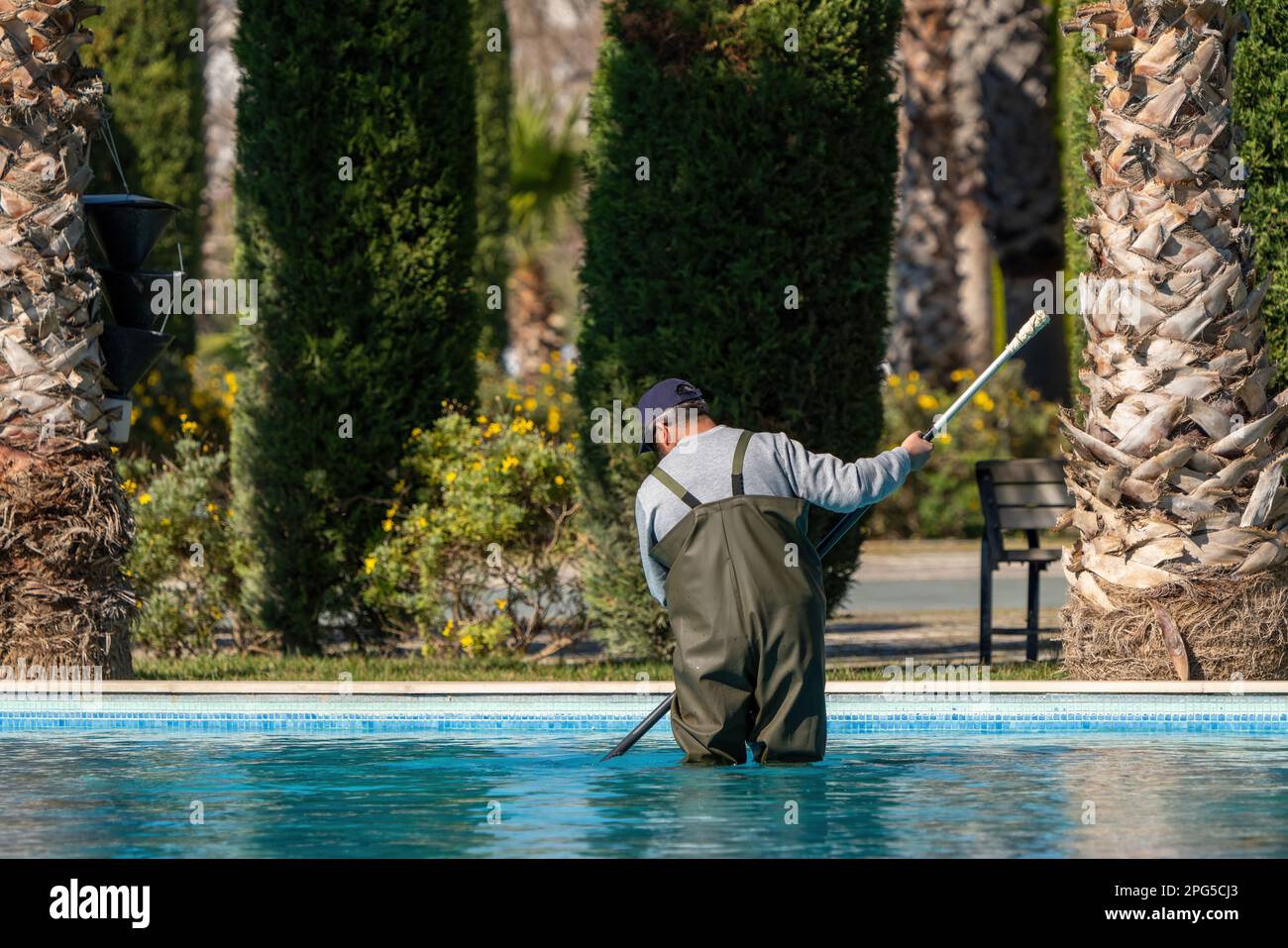 Maintenance worker cleaning the pool Stock Photo - Alamy