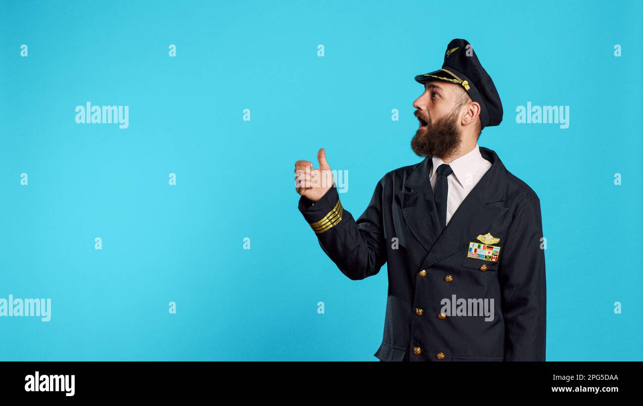 Airline pilot pointing to left or right sides on camera, indicating ...