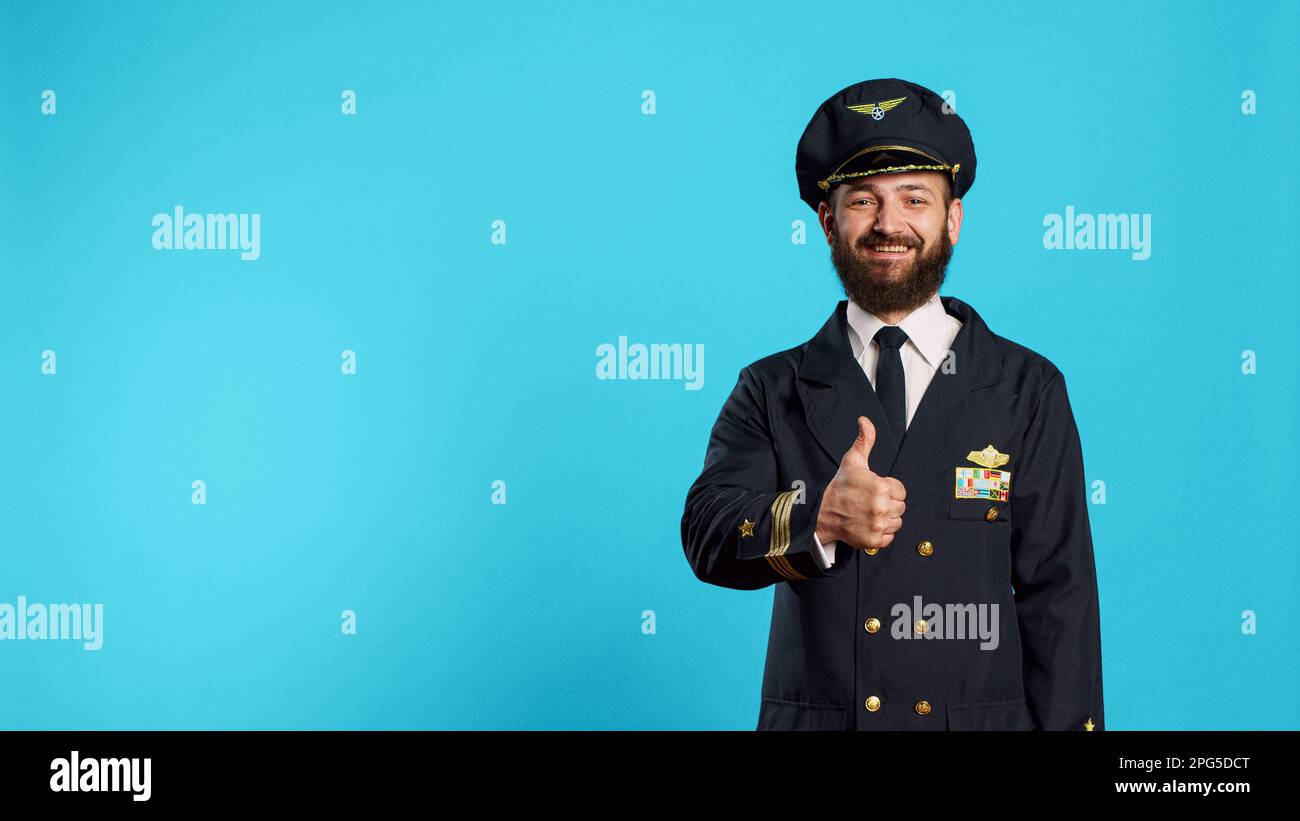 Aviation male pilot giving thumbs up on camera, expressing good sign ...