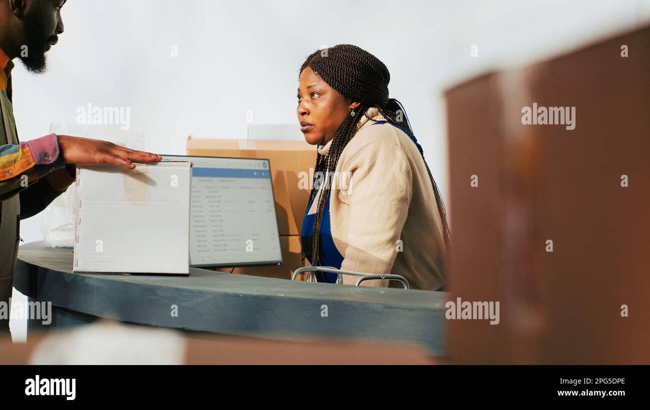 Depot worker planning stock logistics on computer, working with ...