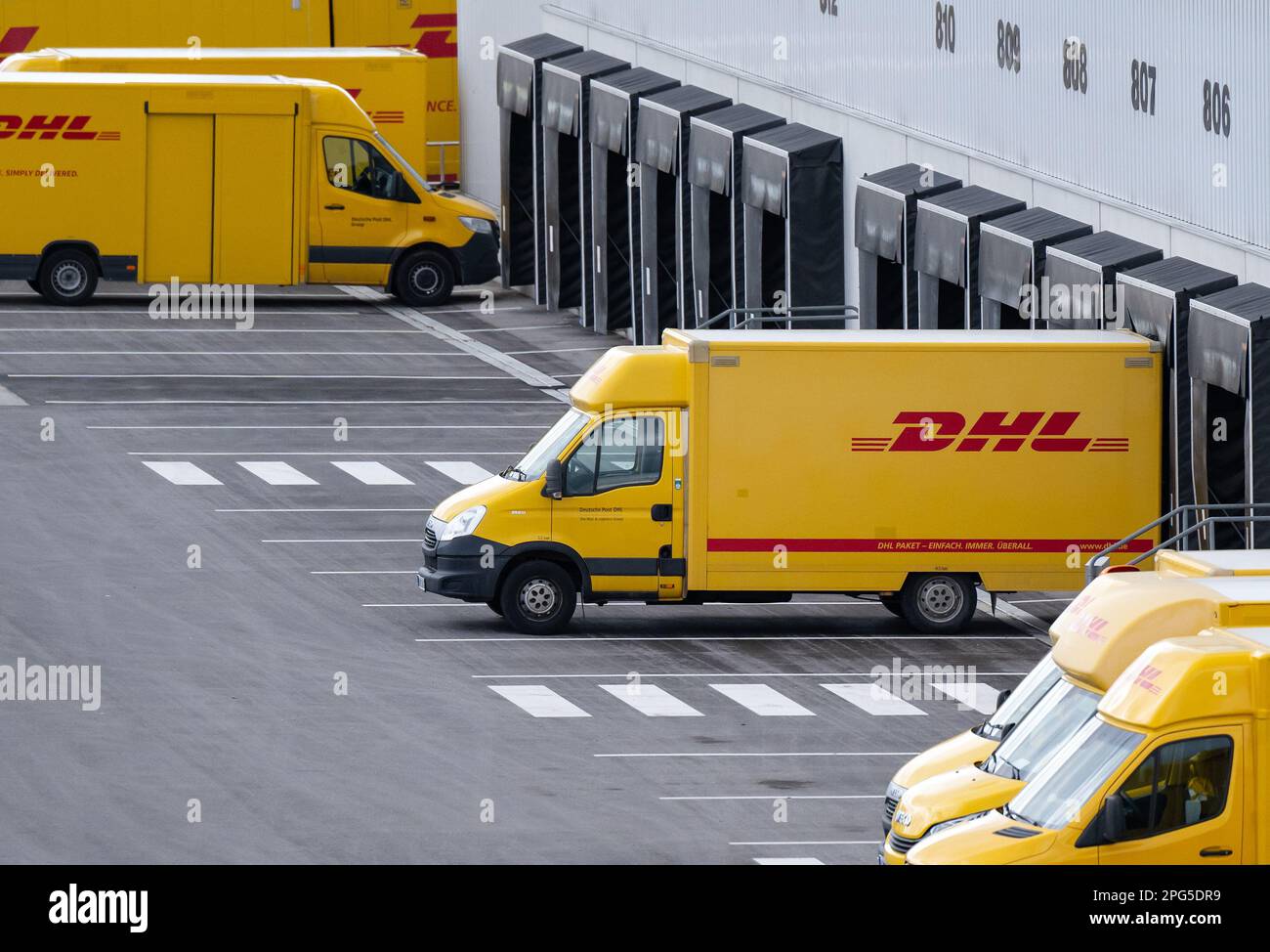 Aschheim, Germany. 20th Mar, 2023. Containers and vehicles with the DHL ...