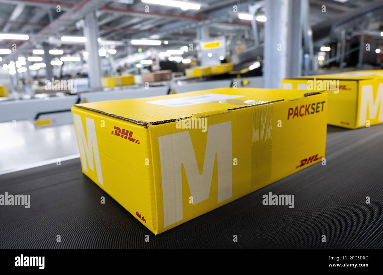 Aschheim, Germany. 20th Mar, 2023. Parcels lie on a conveyor belt in ...