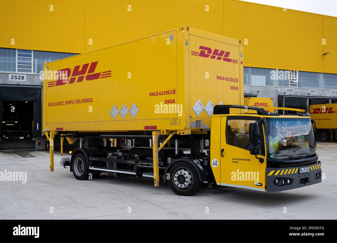 Aschheim, Germany. 20th Mar, 2023. Containers and vehicles with the DHL ...