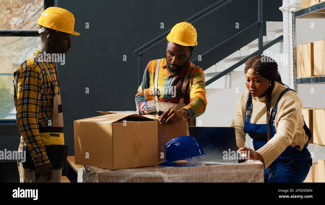 Group of trained workers using depot equipment, working in packaging ...
