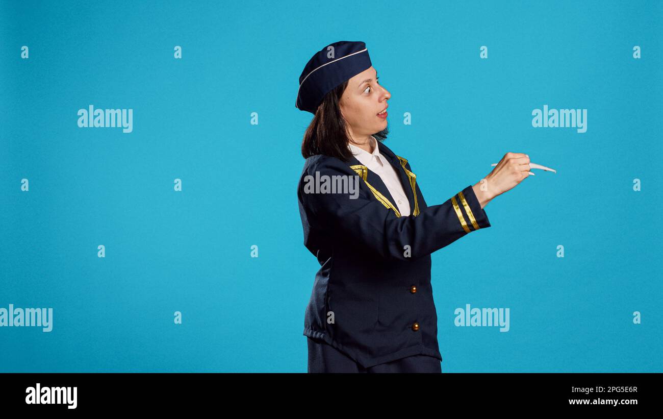 Caucasian woman playing with plane toy, being dressed as stewardess and ...