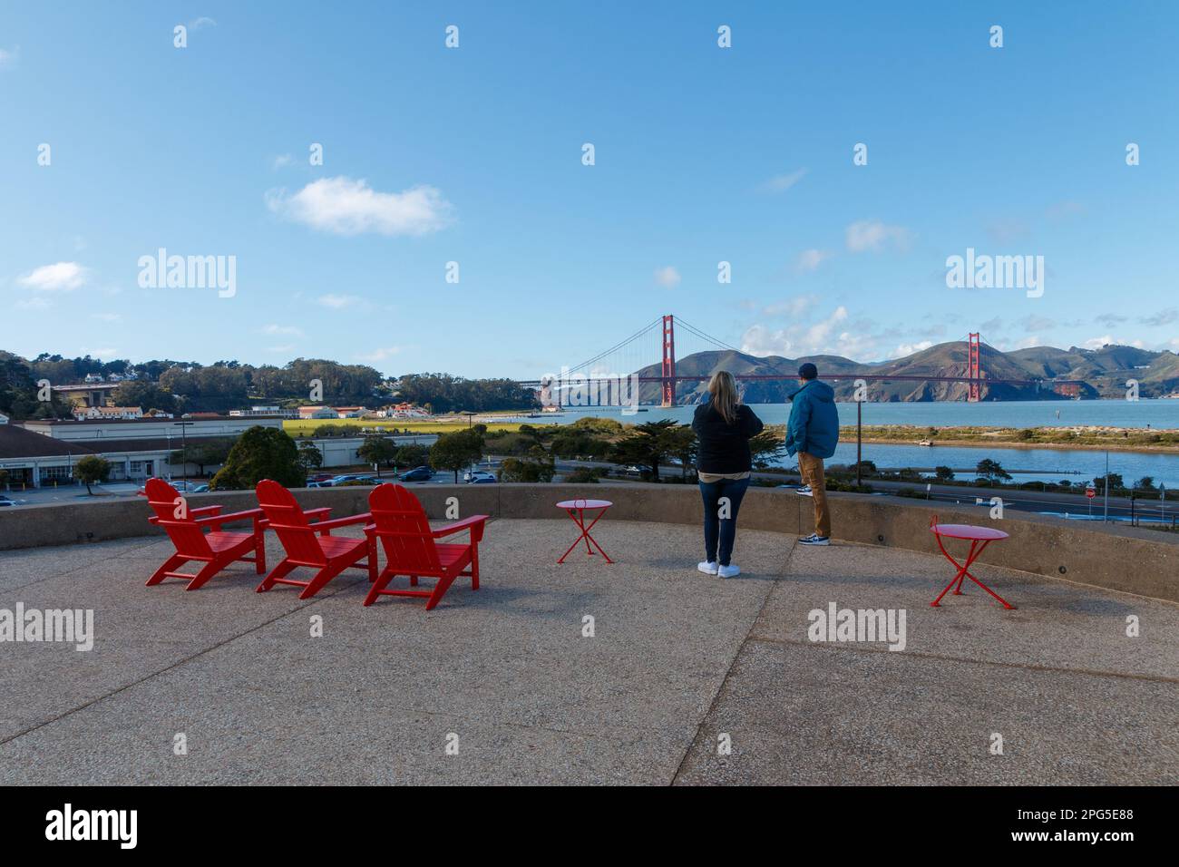 A Brewer's Blackbird sitting on a fence. The bird is facing partly away ...