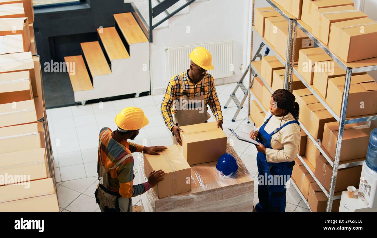 African american people packing products in boxes before doing quality ...