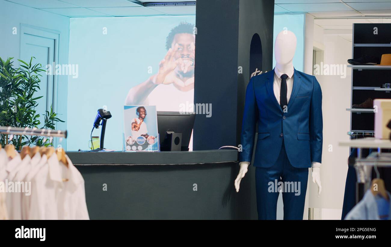 Modern fashionable shop with clothes on hangers, stylish brand design ...