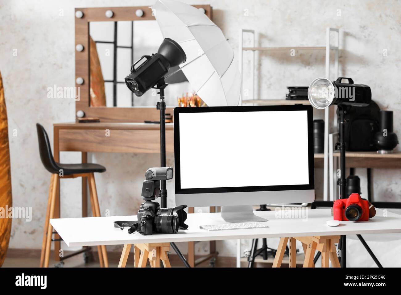 Modern photographer's workplace with computer in studio Stock Photo - Alamy