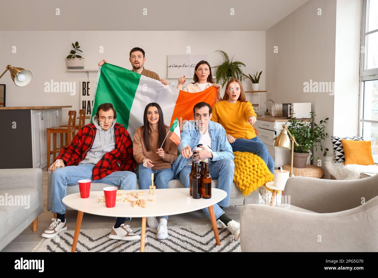 Group of friends with soccer ball and flags of Ireland at home Stock ...