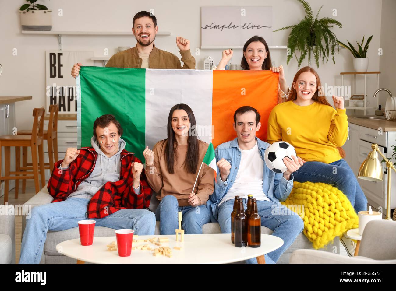 Group of friends with soccer ball and flags of Ireland at home Stock ...