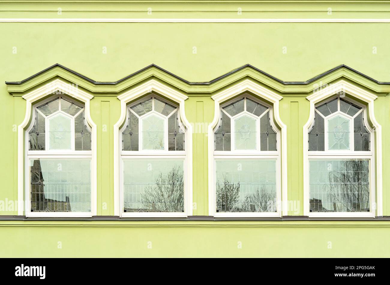 View of green building with white windows Stock Photo - Alamy