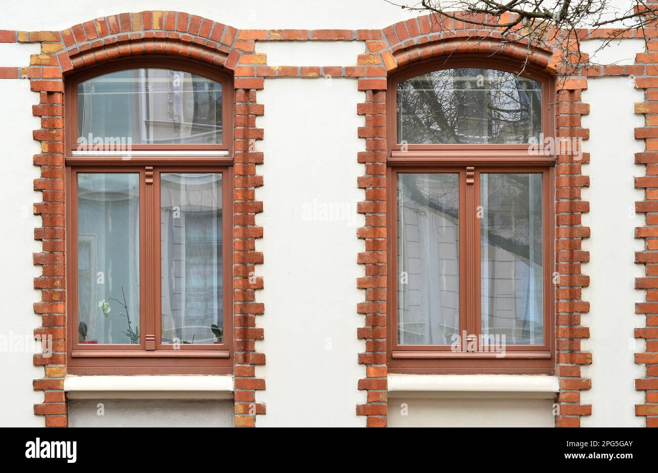 View of brick building with wooden windows Stock Photo - Alamy