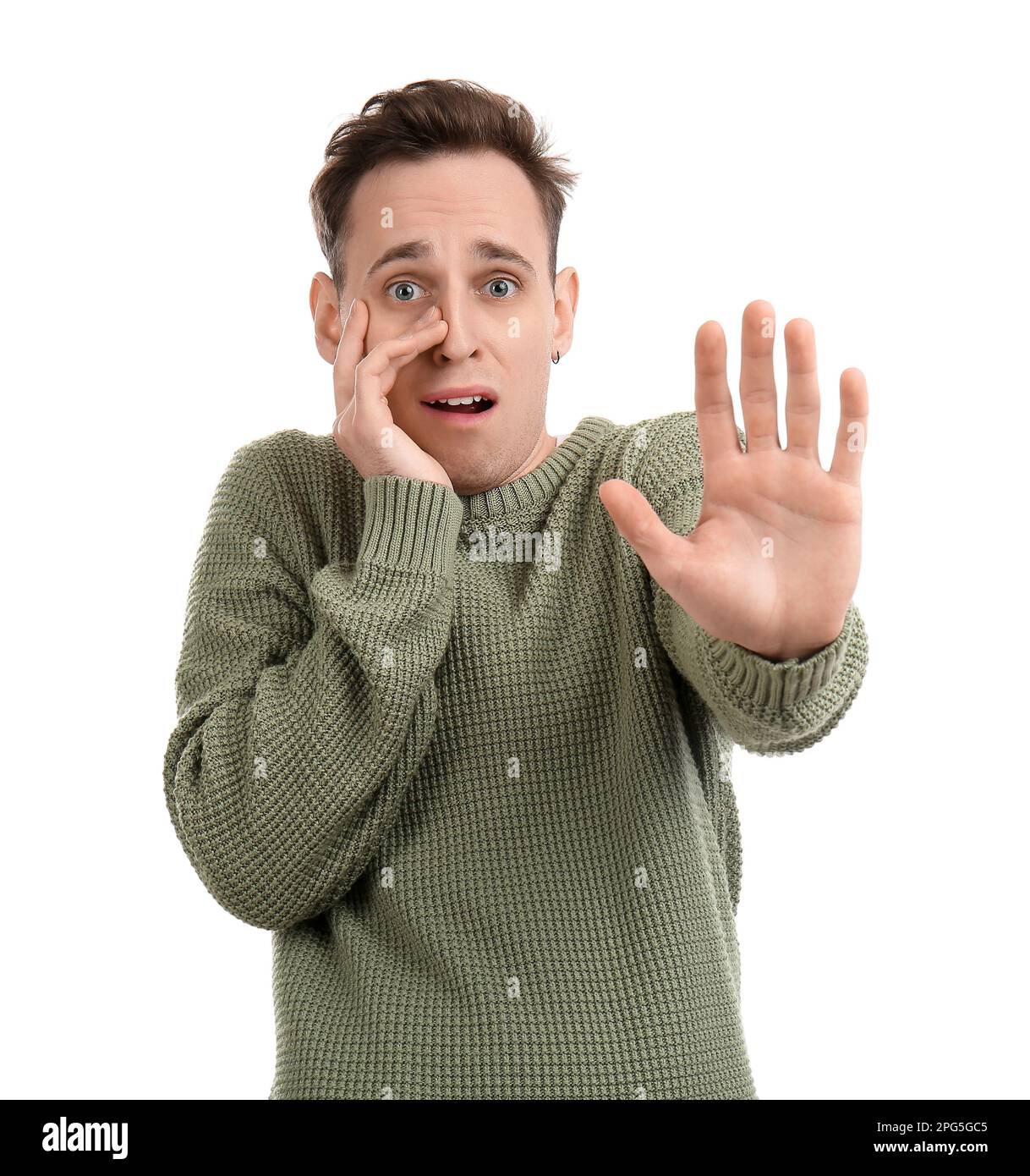 Scared young man on white background Stock Photo - Alamy