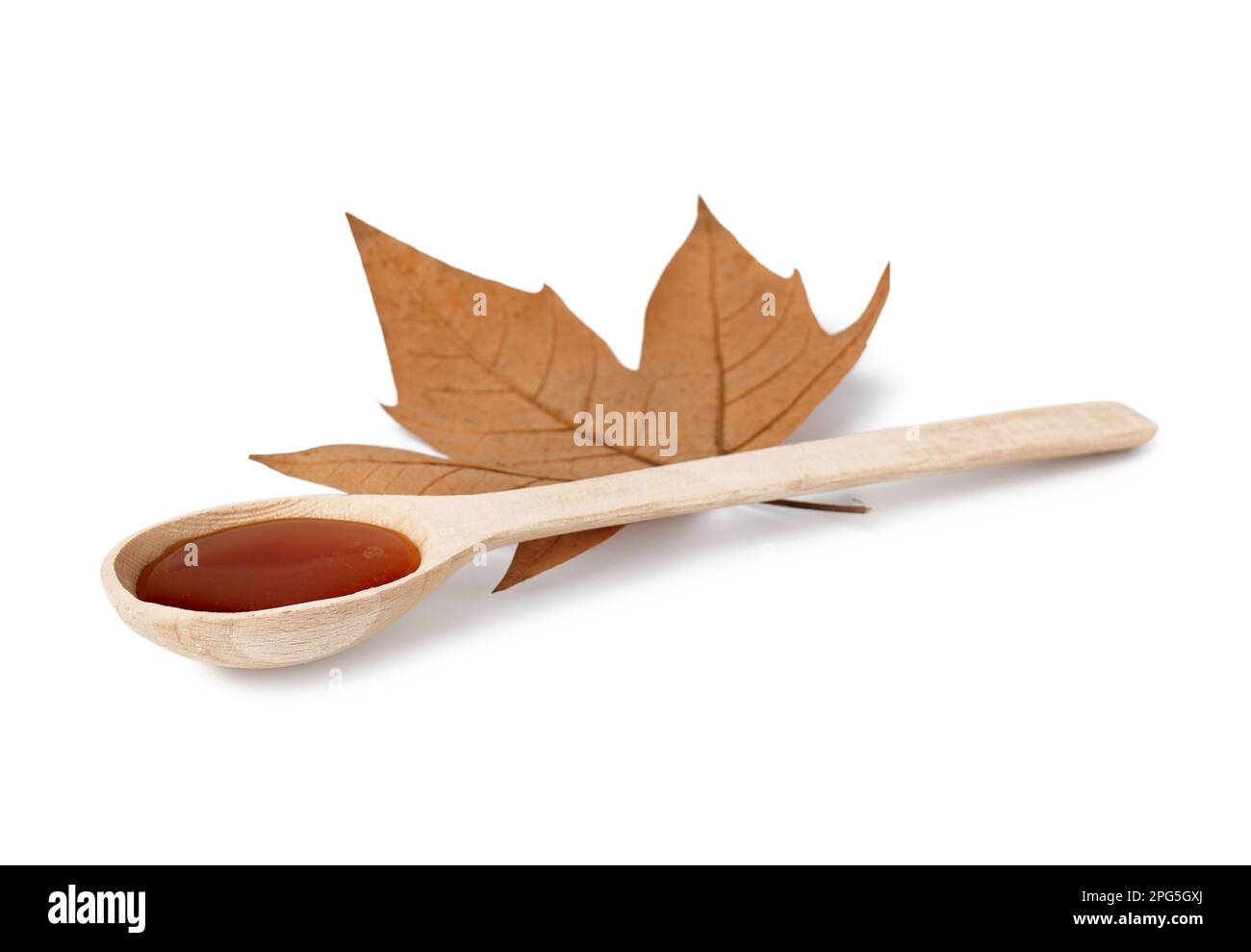 Spoon of tasty maple syrup and leaf on white background Stock Photo - Alamy