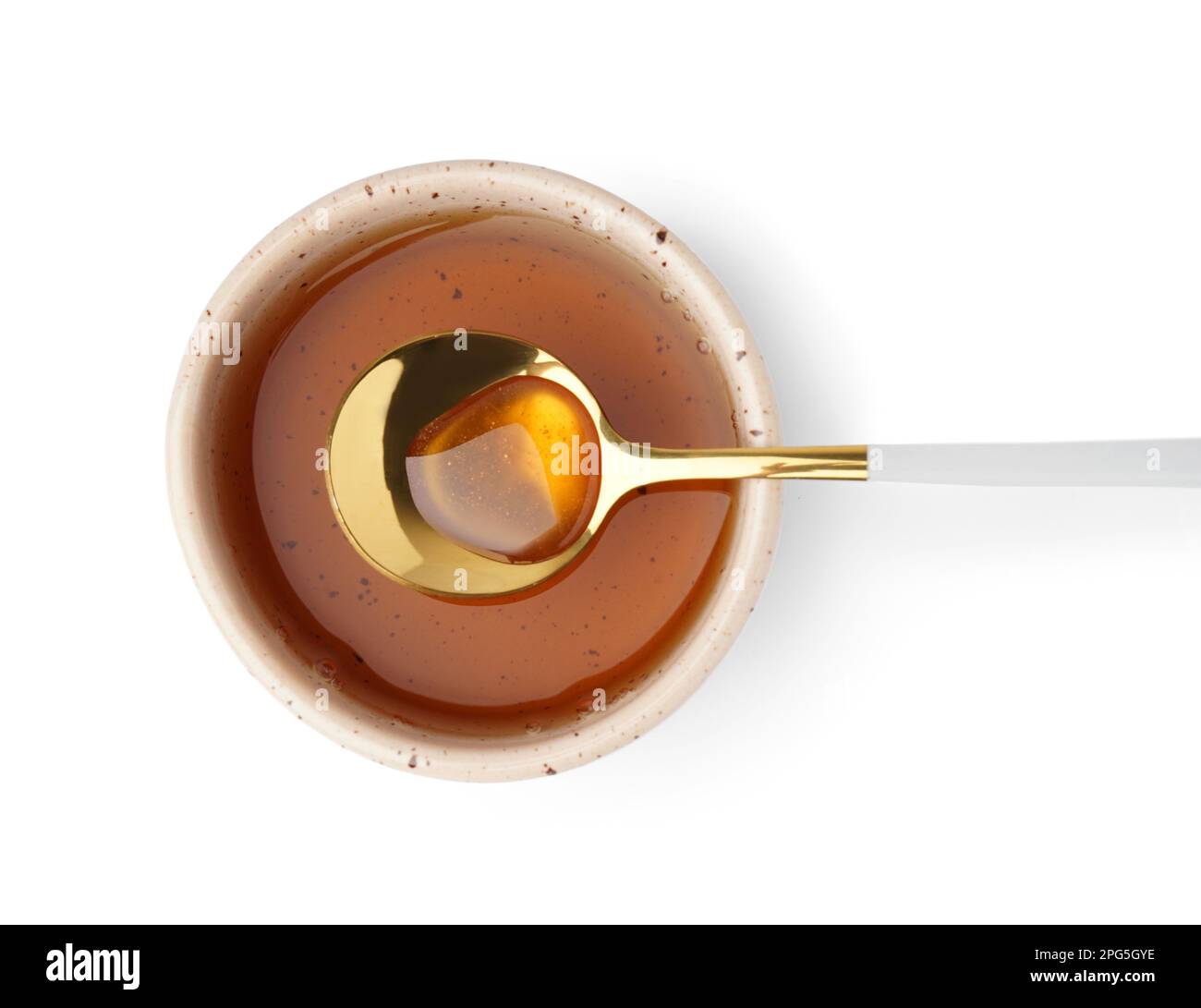 Bowl and spoon of tasty maple syrup on white background Stock Photo - Alamy