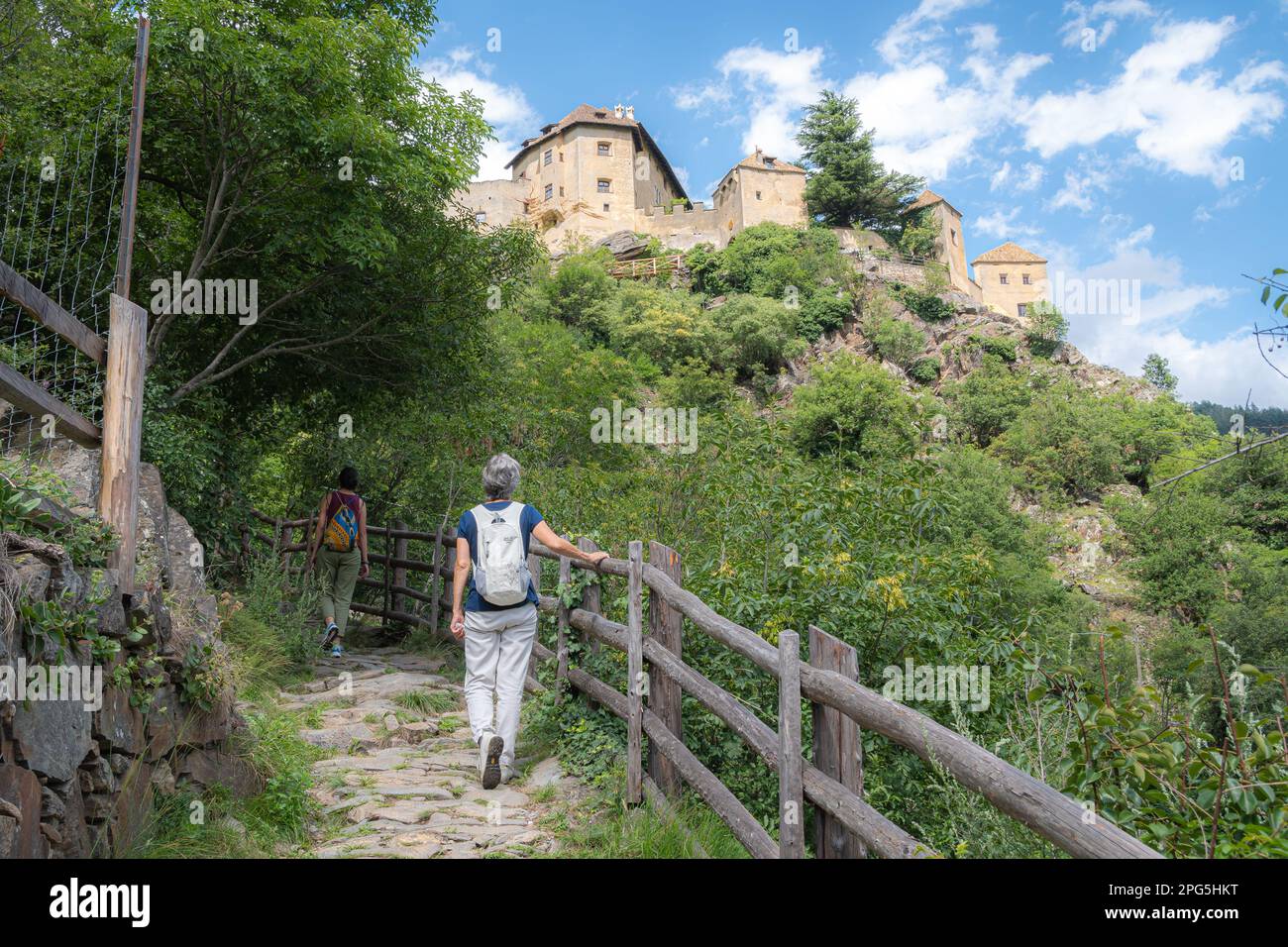 Women hicking by Juval Castle (German: Schloss Juval, Italian: Castel ...
