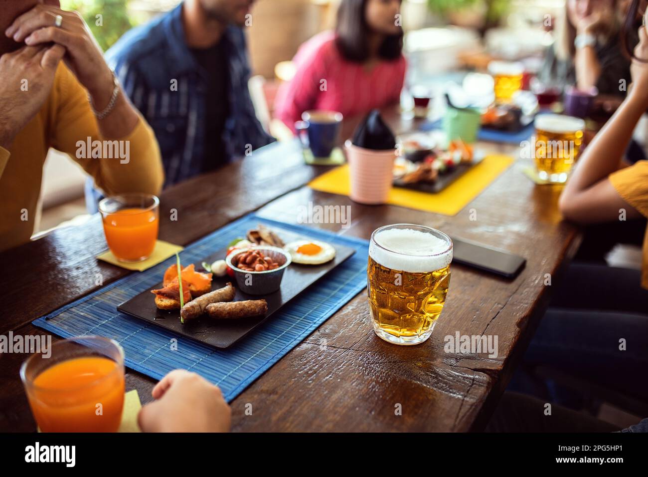 Group of diverse people having lunch at restaurant table Stock Photo ...