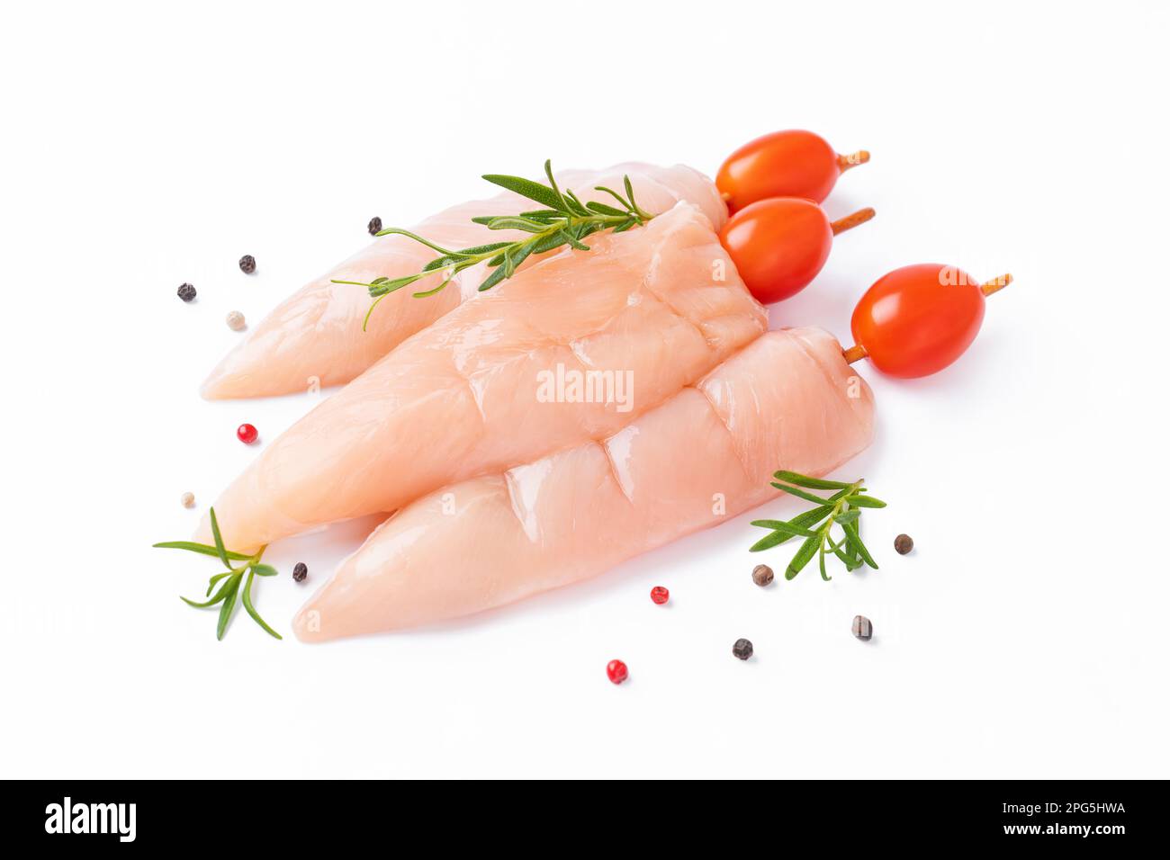 Raw chicken inner on skewers with tomatoes white background with spices ...