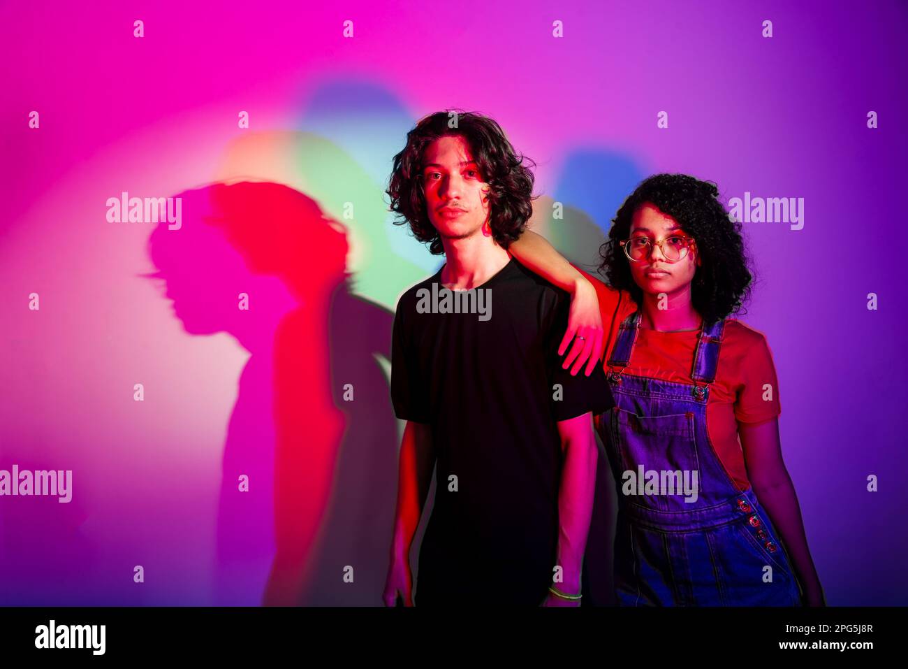 Portrait of two young lovers, isolated on background with colored ...