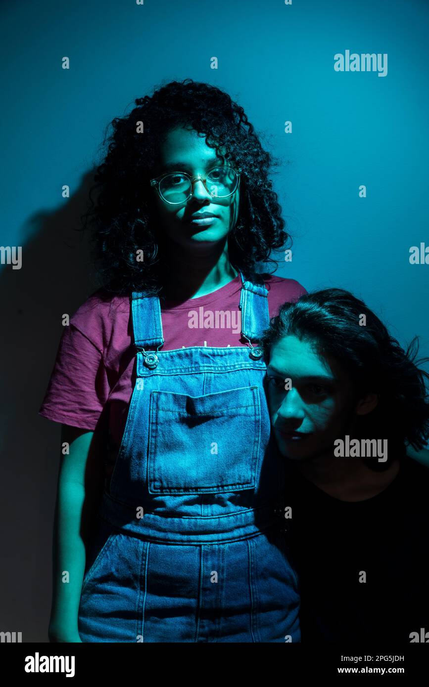 Portrait of young sweethearts with blue color filter. Click studio ...