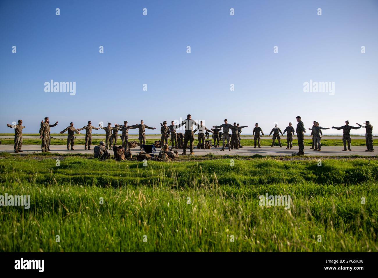 U.S. Marines in the ANGLICO Basic Course execute a dynamic warm up in ...