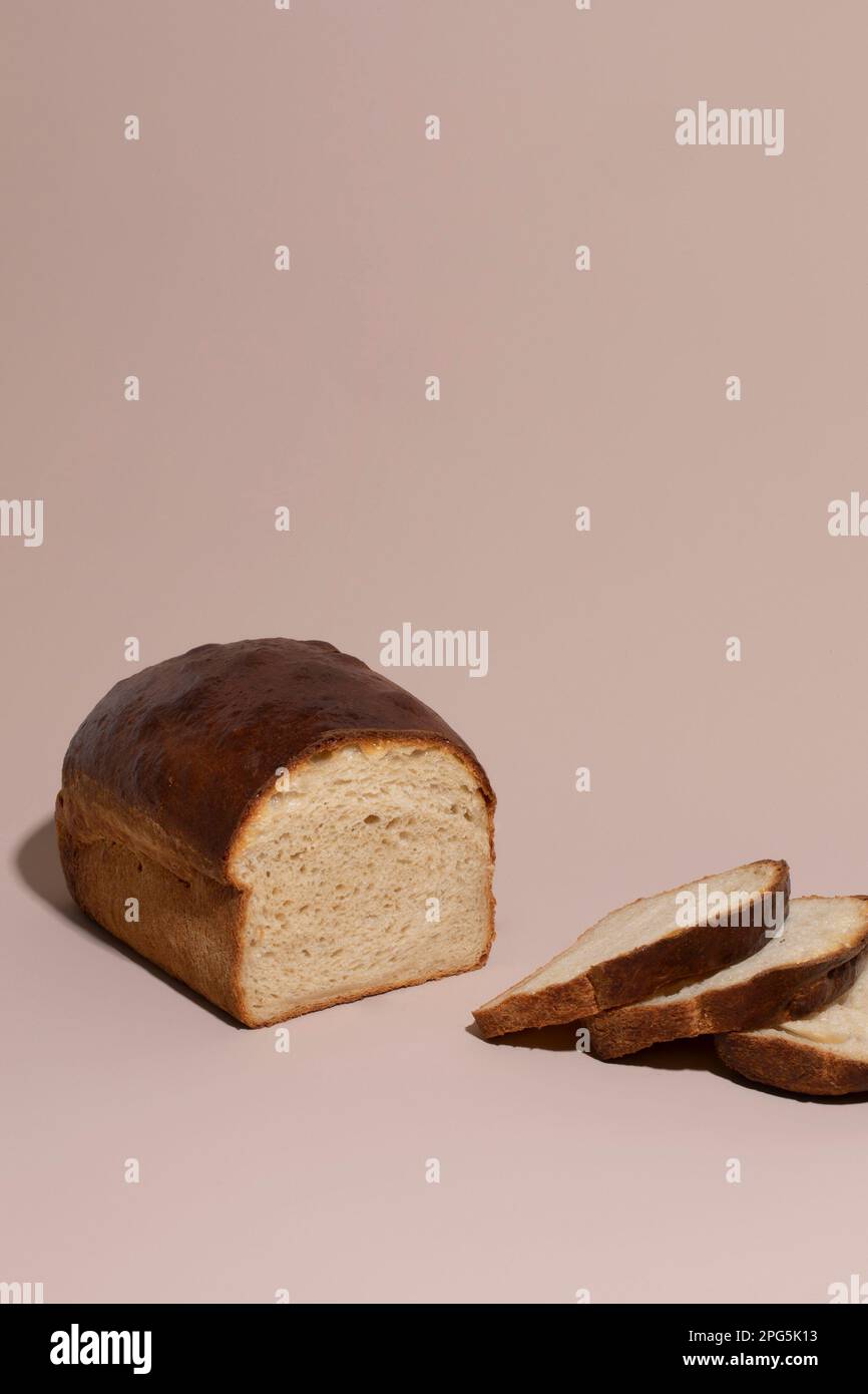 Loaf of sliced Milk bread on Taupe Background Stock Photo - Alamy