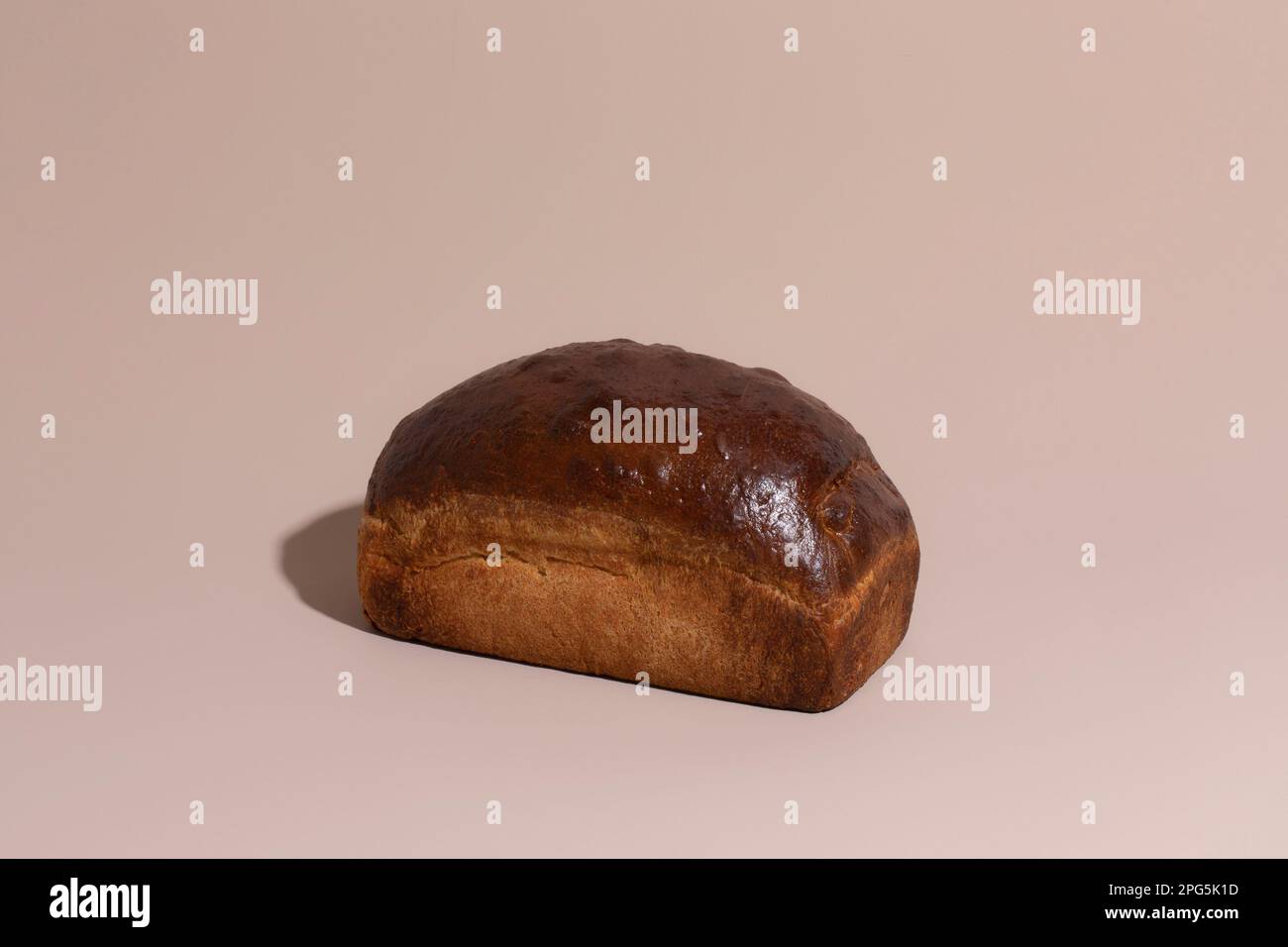 Loaf of shiny Milk bread on Taupe Background Stock Photo - Alamy