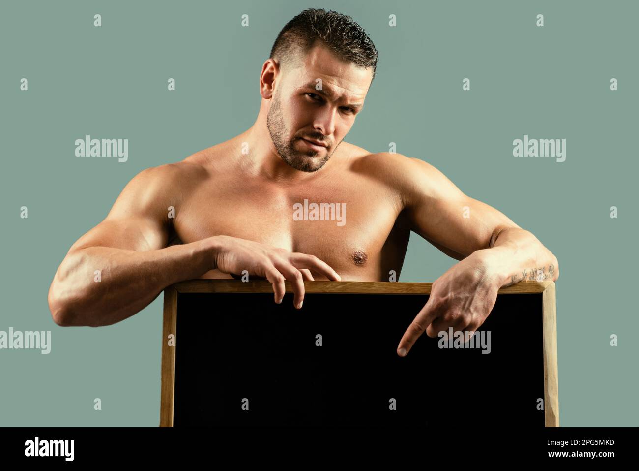 Fitness man with advertising sign board. Handsome muscular bodybuilder ...