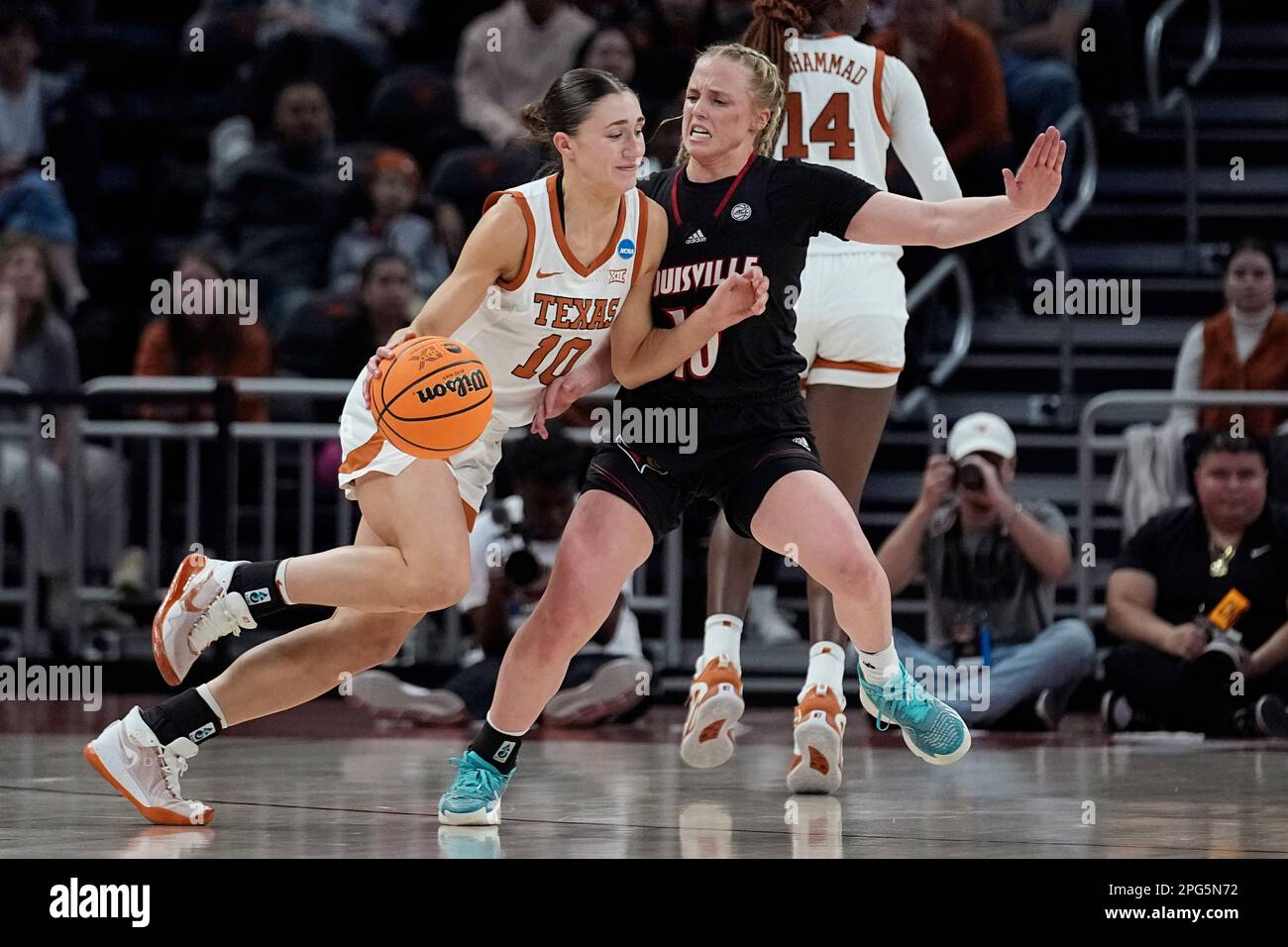 Texas guard Shay Holle, left, drives around Louisville guard Hailey Van ...