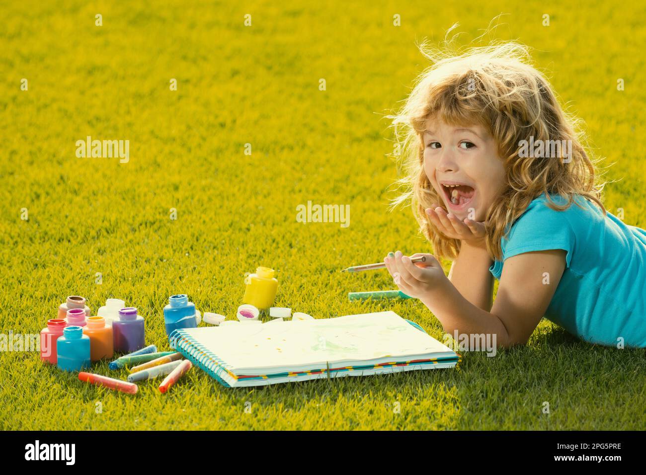Kids drawing. Child boy enjoying art and craft drawing in backyard or ...