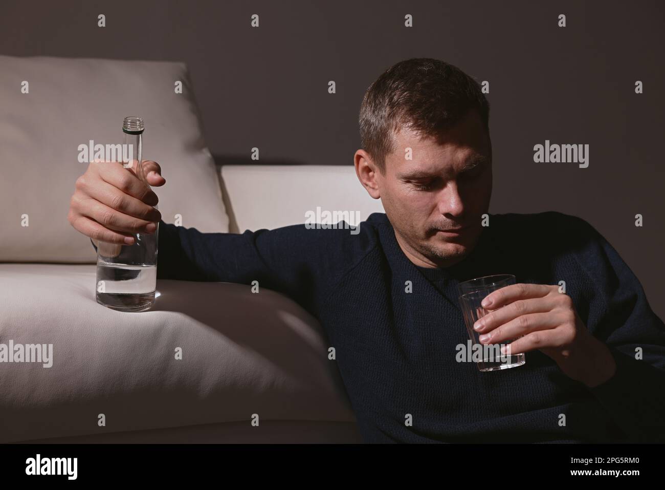 Alcoholic man sofa addiction hi-res stock photography and images - Alamy