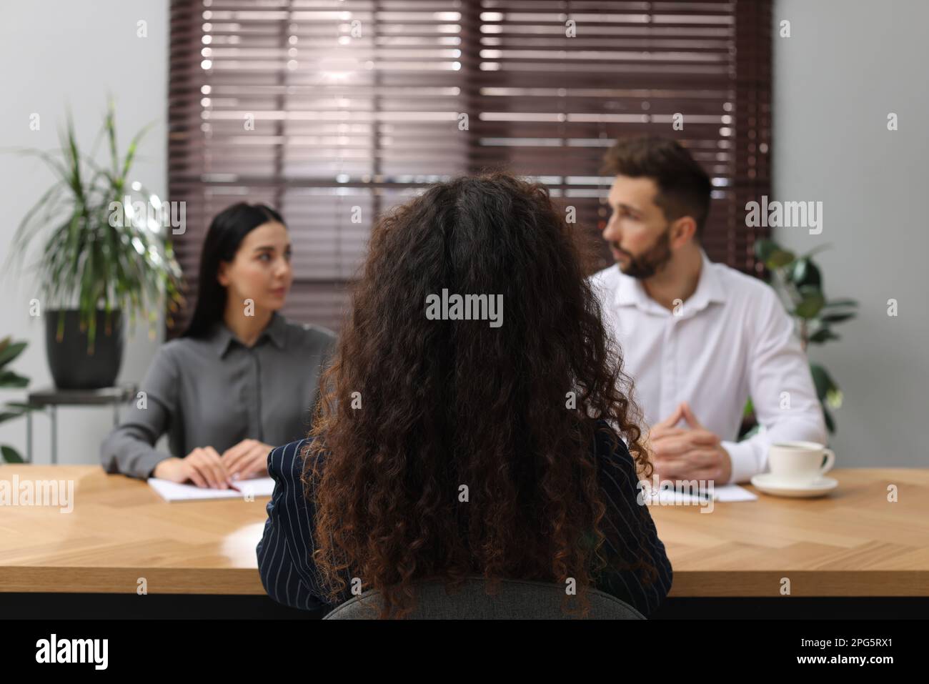 Coworkers conducting job interview with African American woman in ...