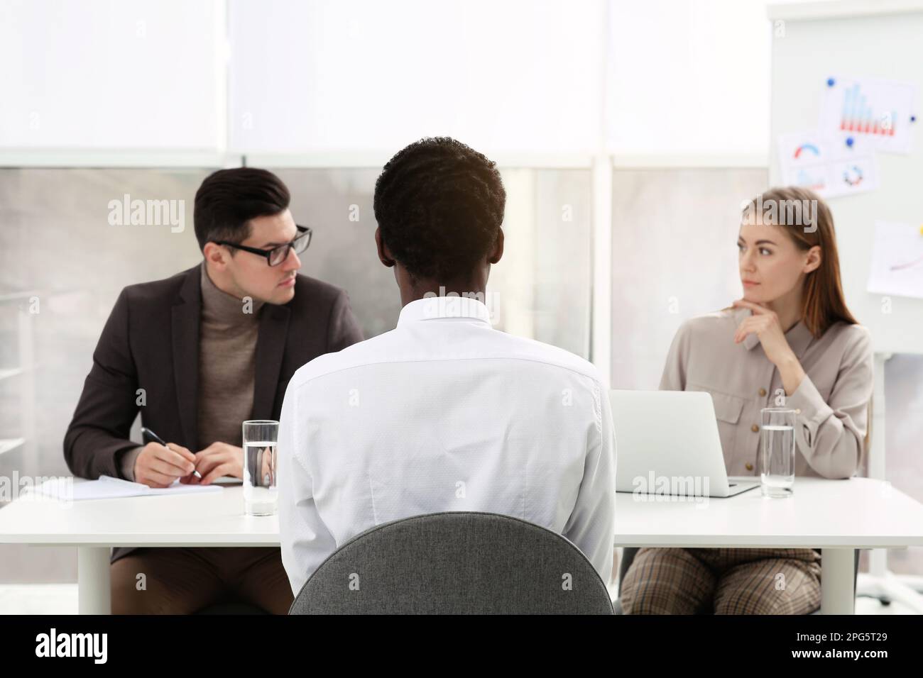 Coworkers conducting job interview with African American man in office ...