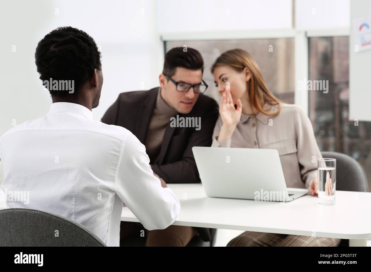 Coworkers conducting job interview with African American man in office ...