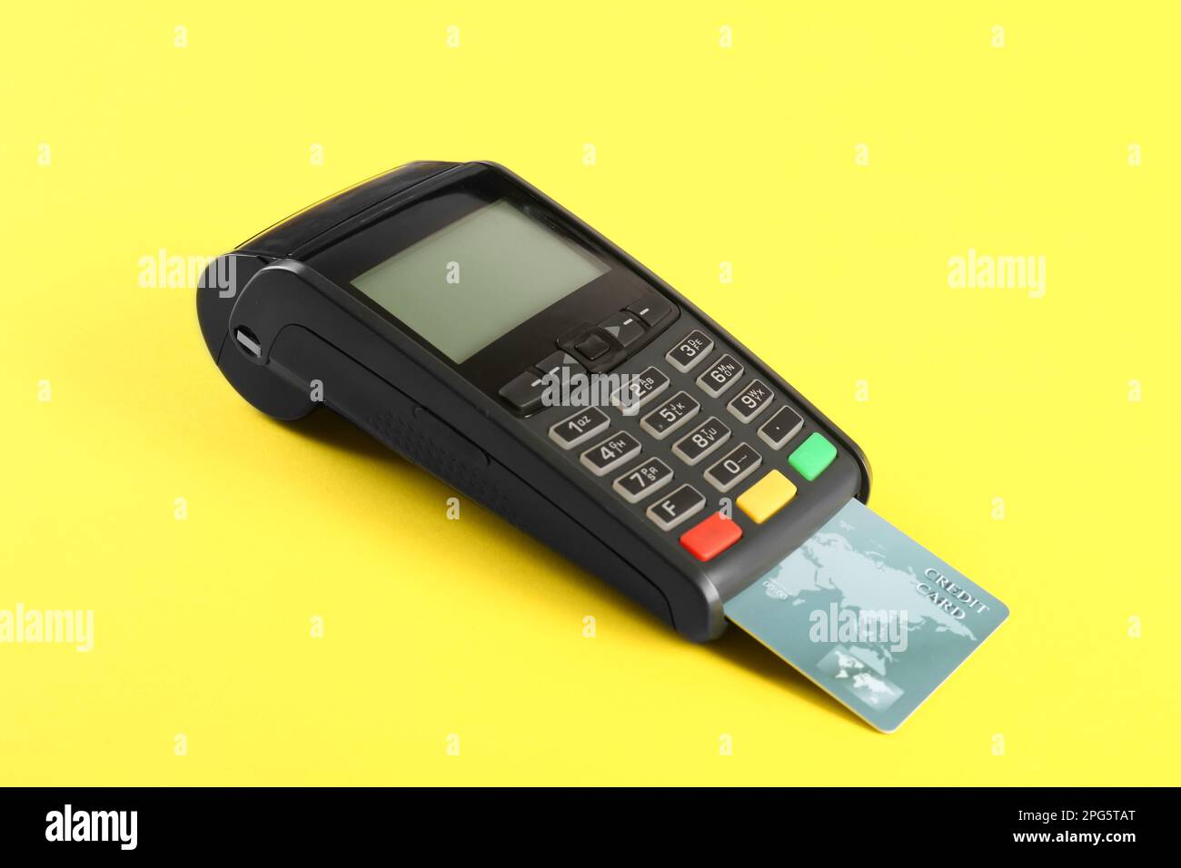 New modern payment terminal with credit card on yellow background Stock ...