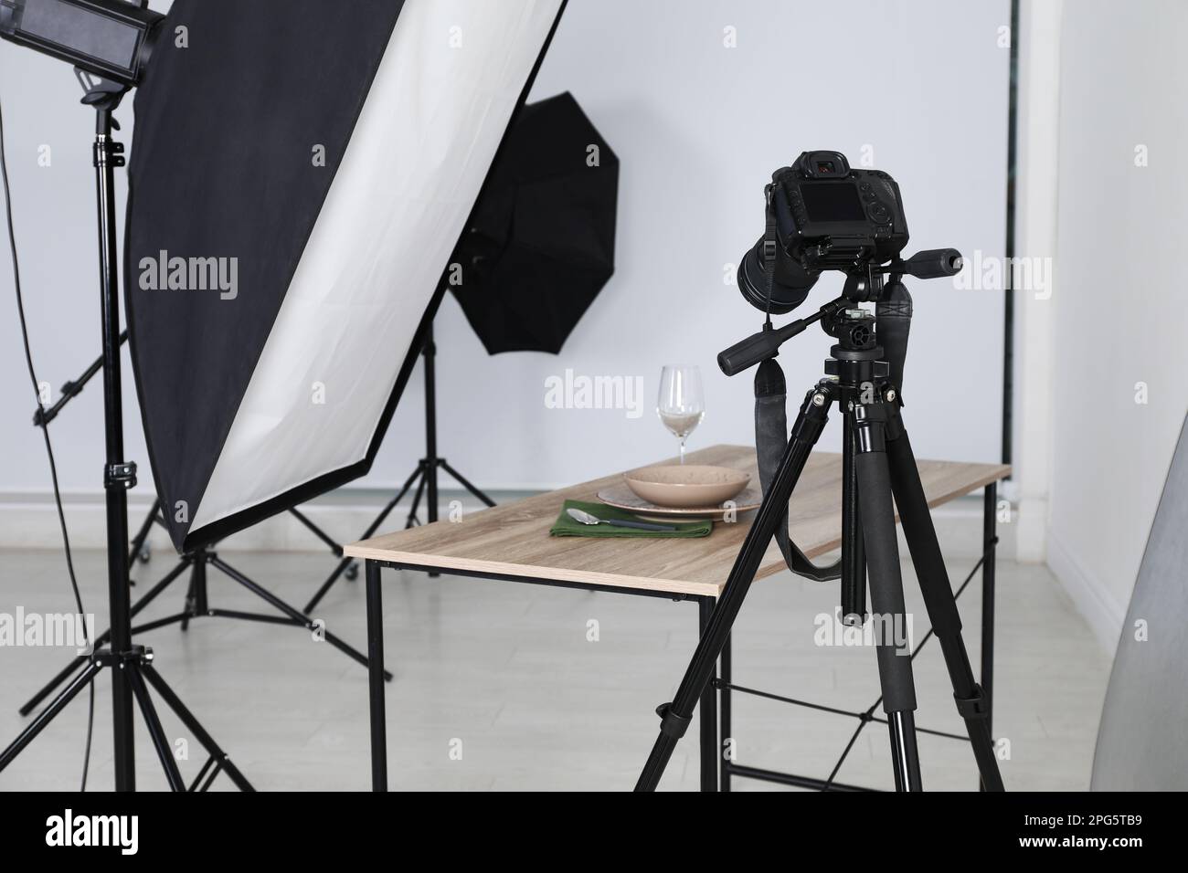 Table with stylish dinnerware in front of camera and professional ...