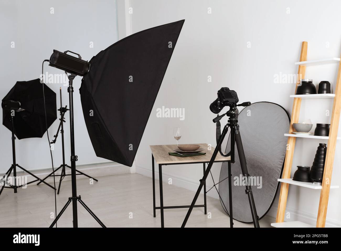 Table with stylish dinnerware in front of camera and professional ...